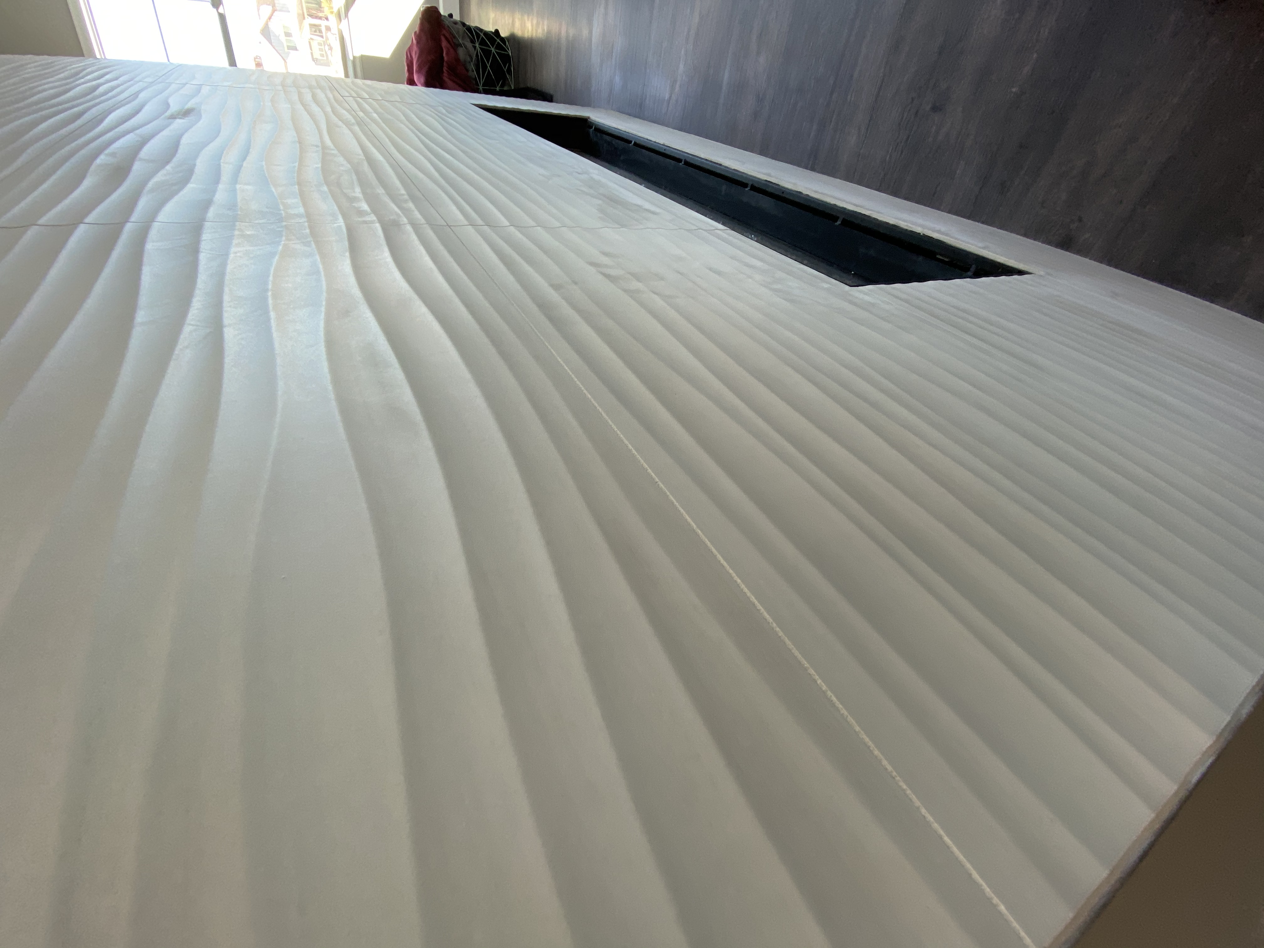 Wavy porcelain tile on the fireplace surround up to the ceiling by ...